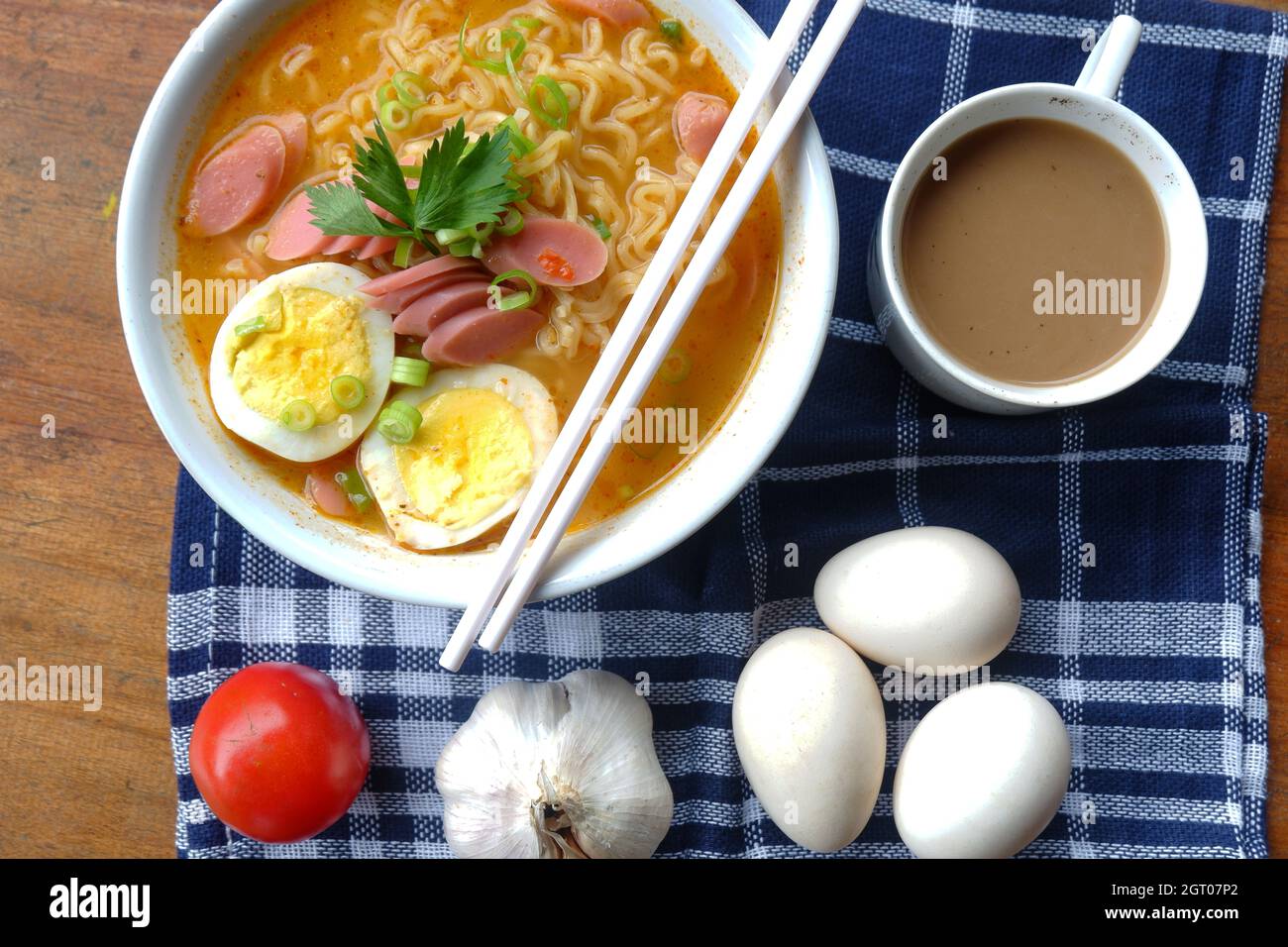 Top view of a bowl of delicious ramen with sausages on the table with ...