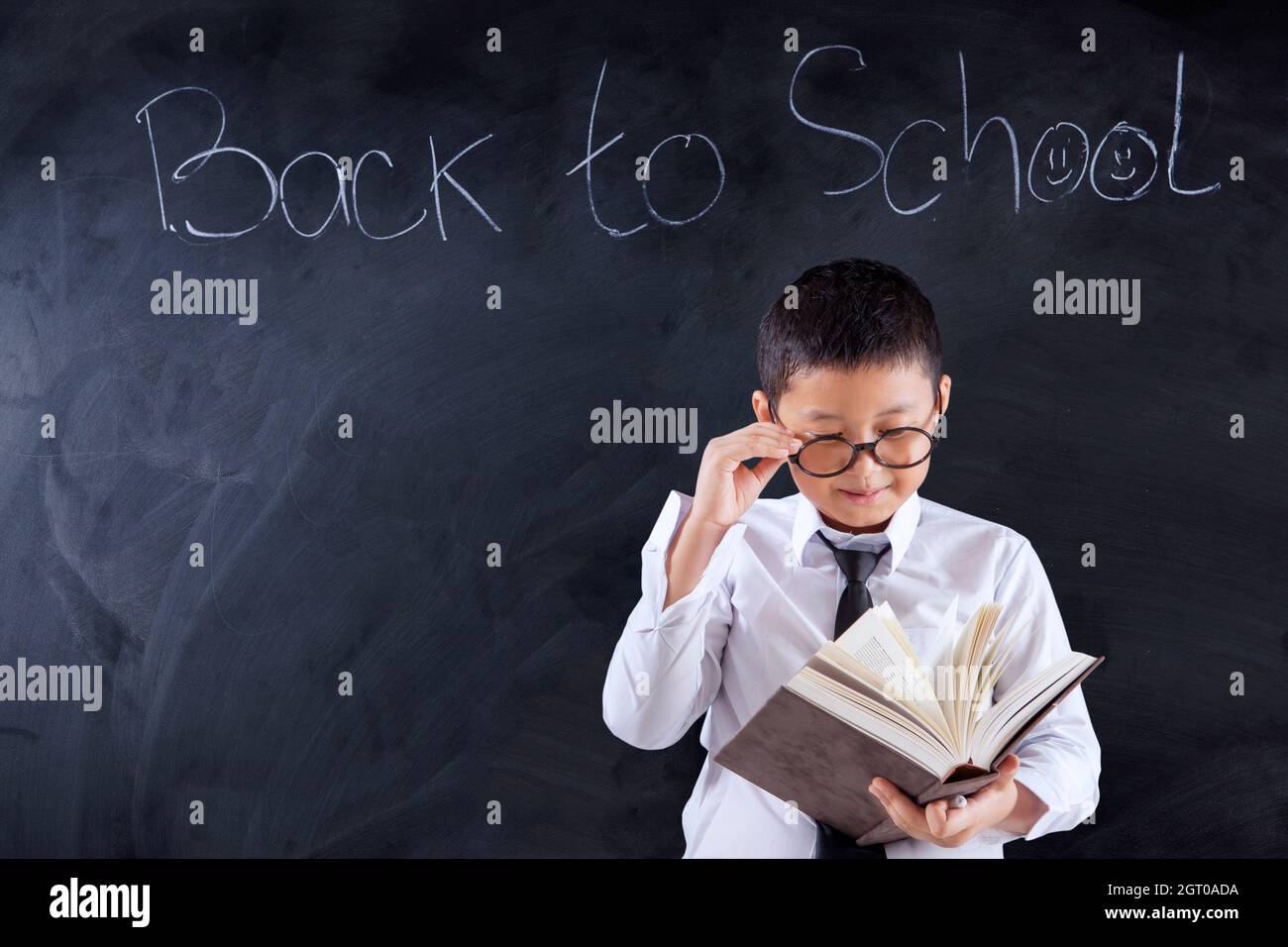 Boy reading in front blackboard hi-res stock photography and images - Alamy