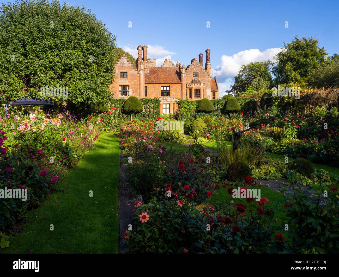 Chenies Manor house in Autumn seen from the Sunken garden with many ...