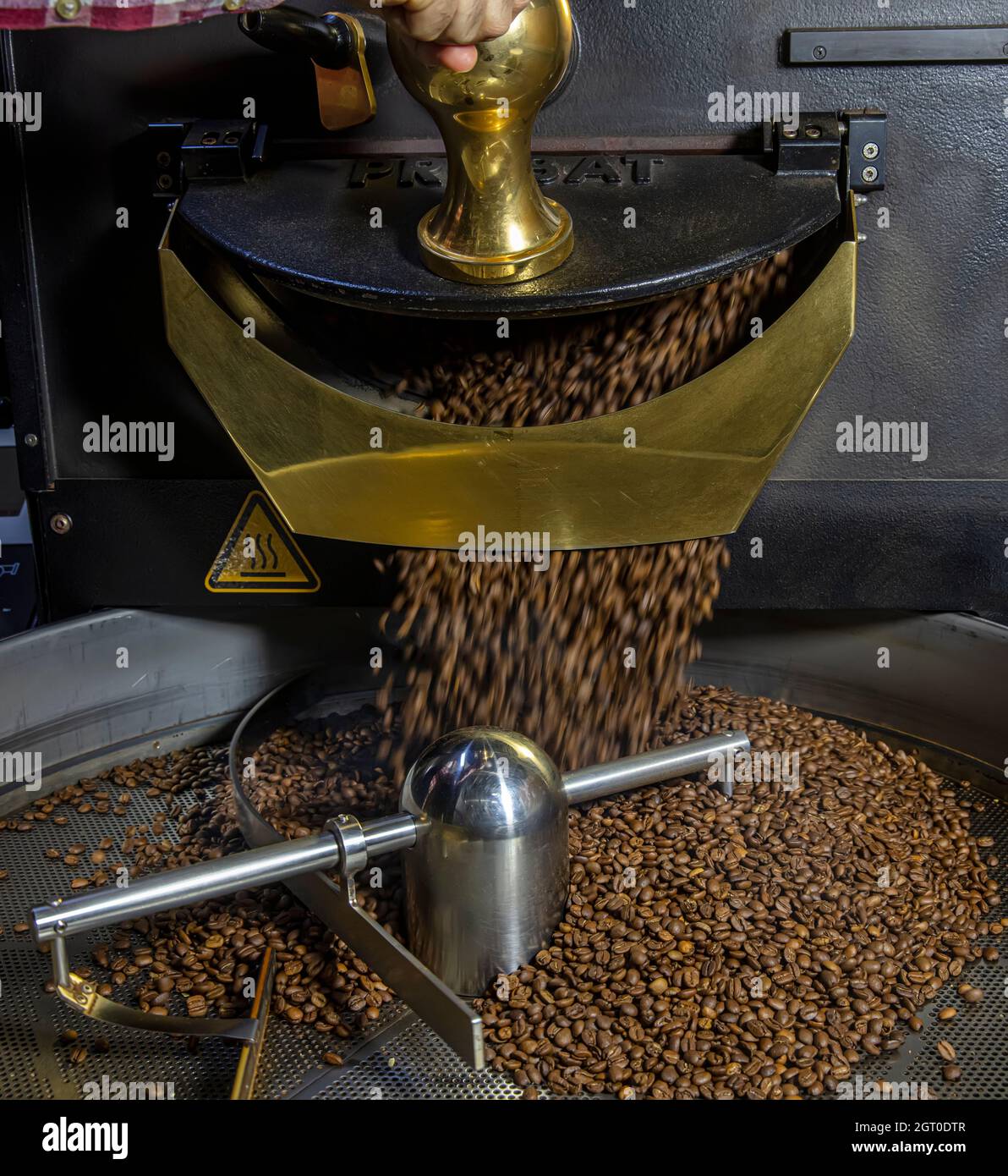 Coffee roaster machine at coffee roasting process. Mixing coffee beans ...