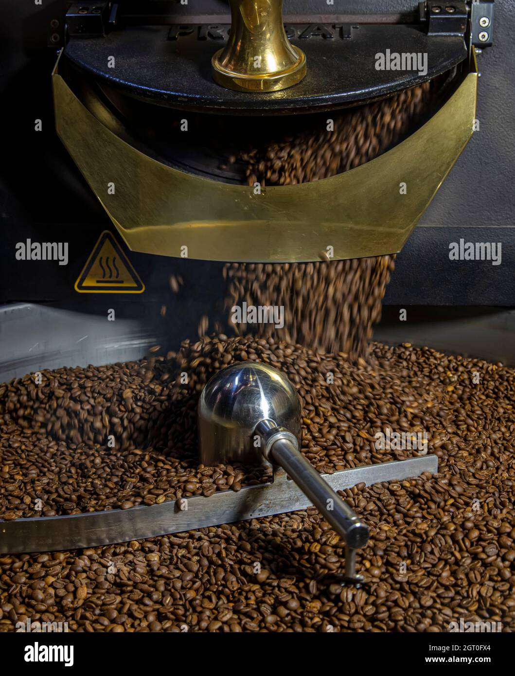 Coffee roaster machine at coffee roasting process. Mixing coffee beans ...