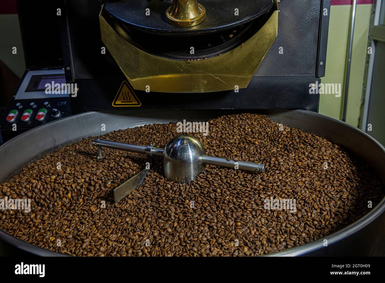 Coffee roaster machine at coffee roasting process. Mixing coffee beans ...