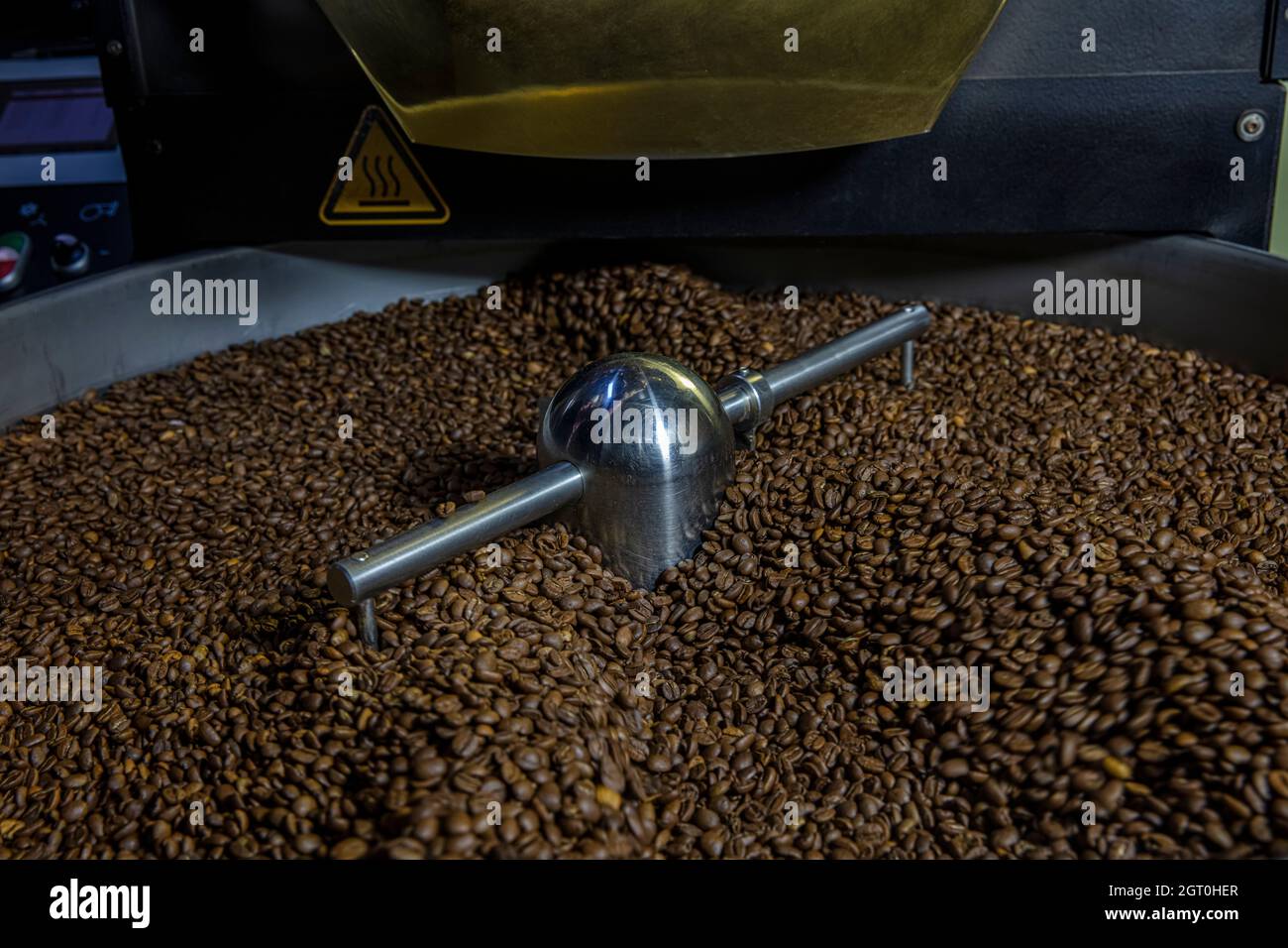 Coffee roaster machine at coffee roasting process. Mixing coffee beans ...