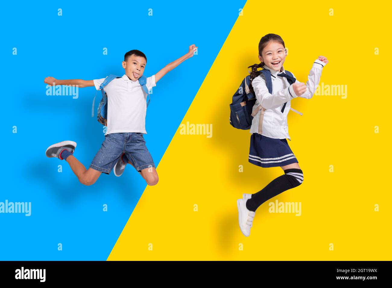Happy student boy and girl jumping Stock Photo - Alamy