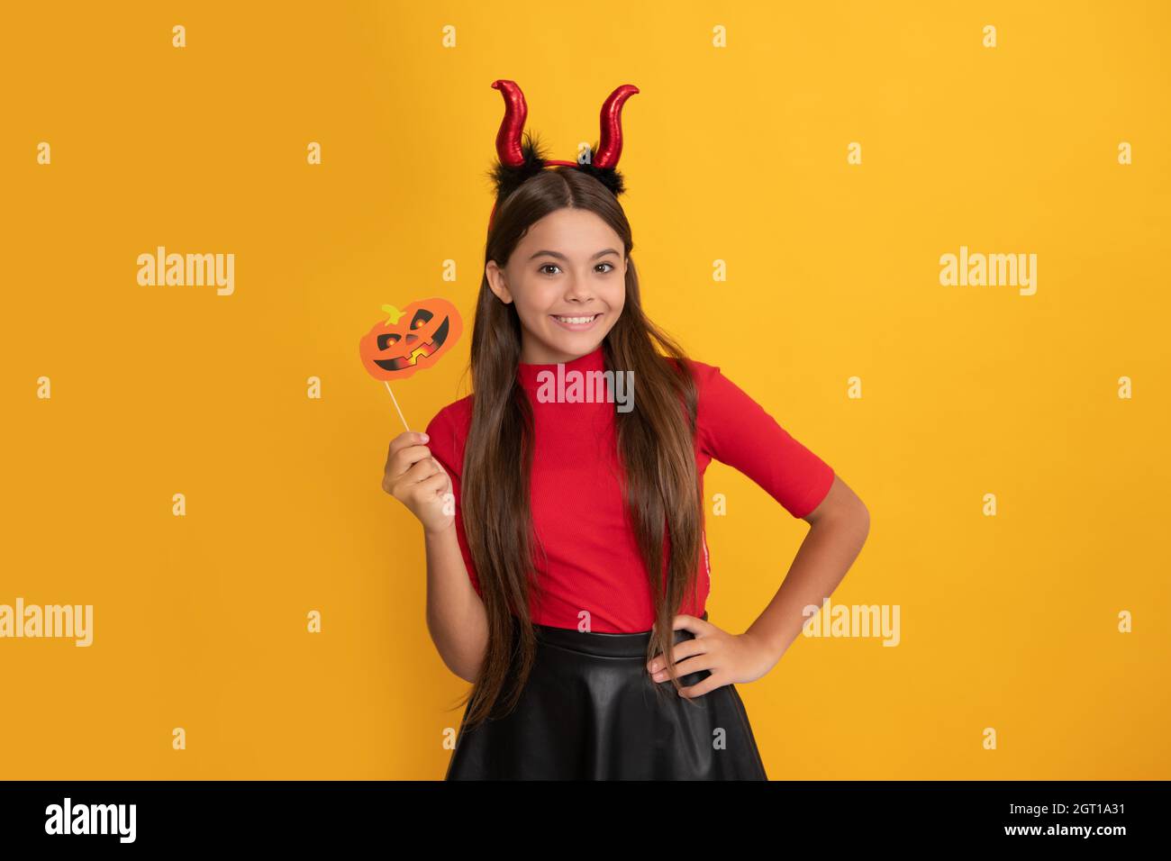 happy halloween. devil kid with pumpkin party accessory. trick or treat ...