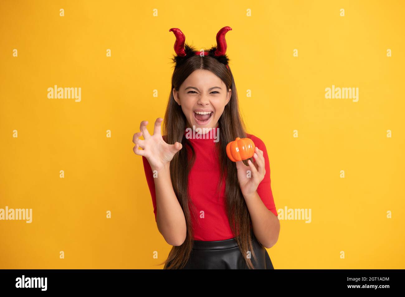 evil child in imp horns. happy halloween. devil kid with pumpkin. trick ...