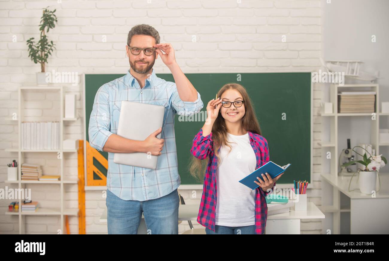 happy father and child study at school with book and laptop on ...