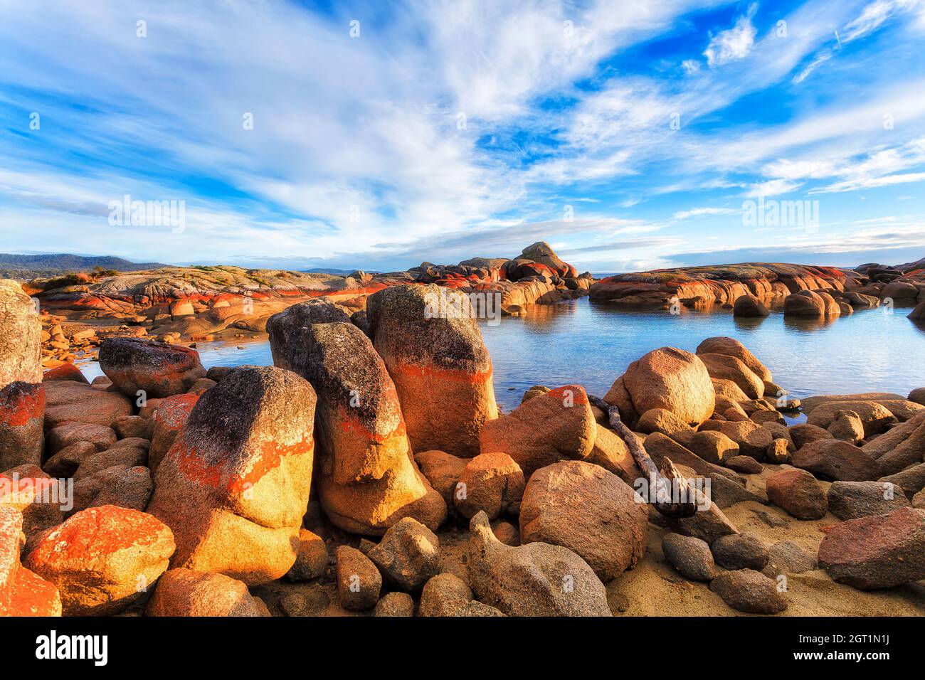 Bay of fires red covered basalt boulders in soft morning light - travel ...