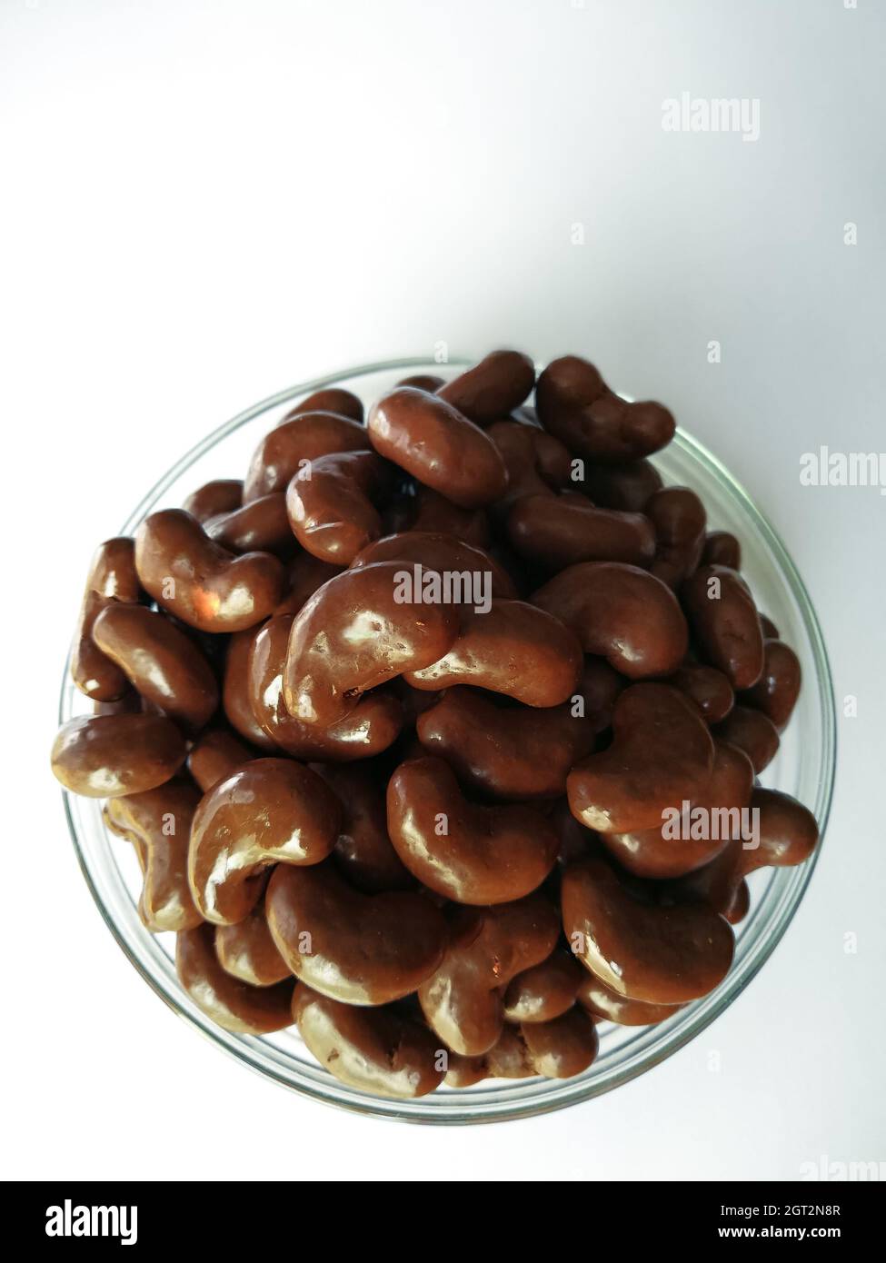 Chocolate Bean Shaped In A Bowl On White Background Stock Photo - Alamy