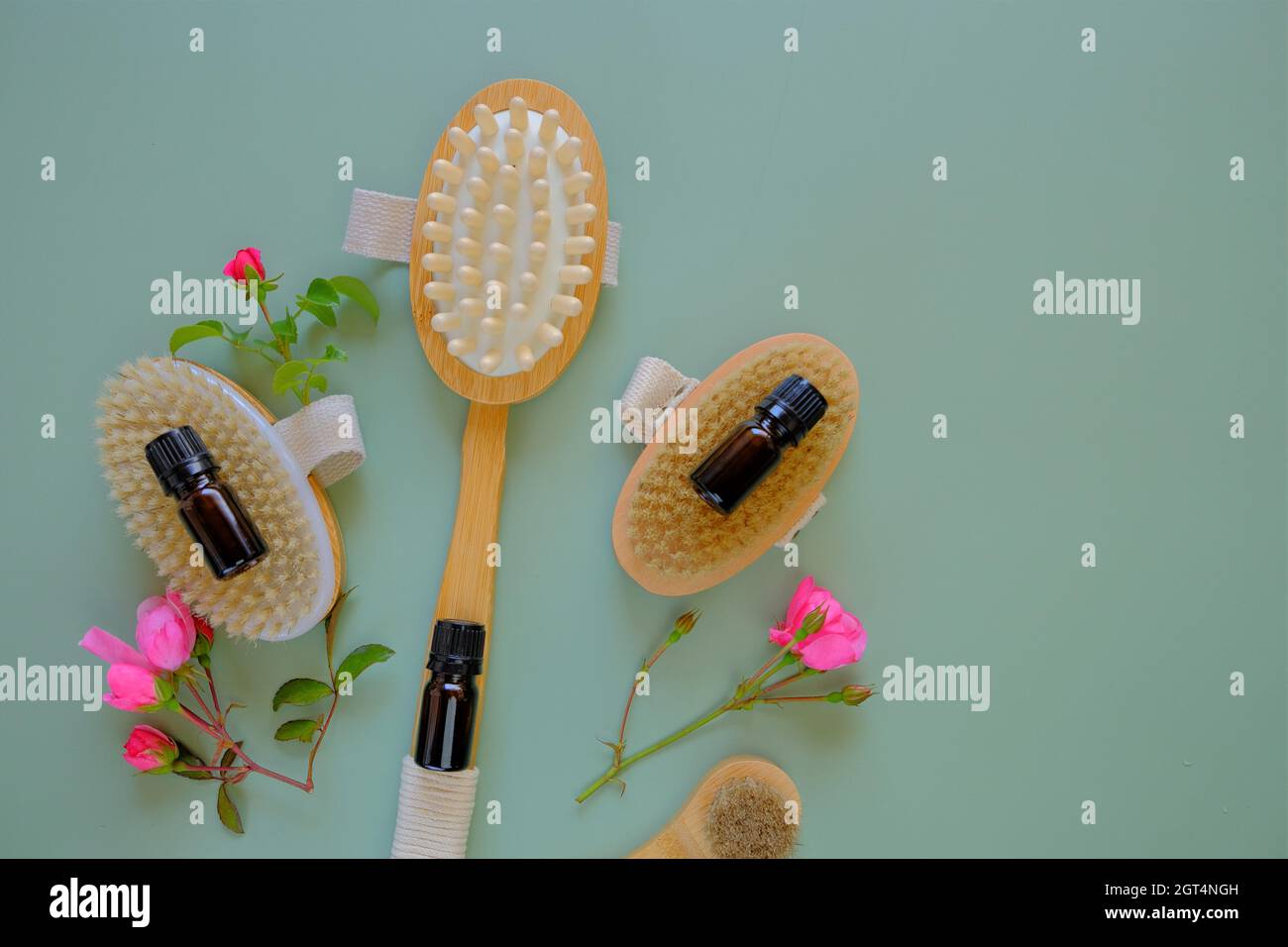 Rose oil. Spa, massage and aromatherapy. Massage brushes set, oil in ...