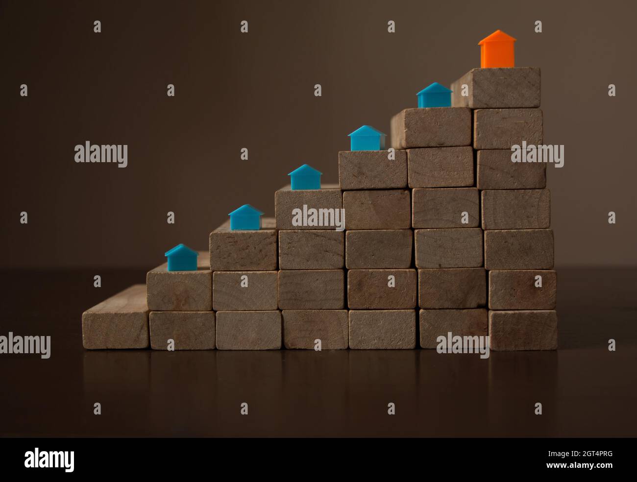 Increasing House Models Arranged In A Row On Wooden Stack Staircase ...