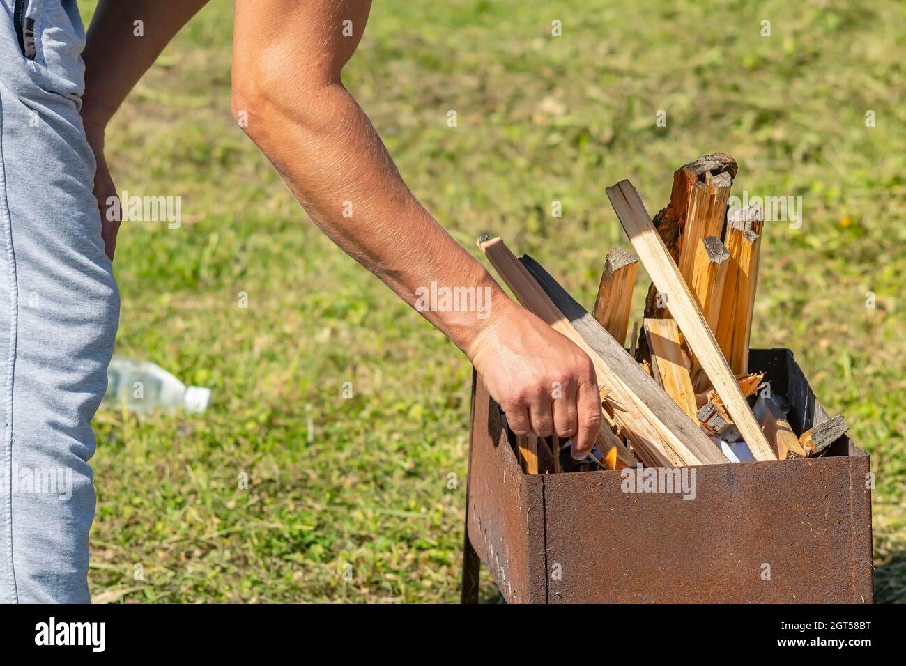 Man lights fire in grill hi-res stock photography and images - Alamy