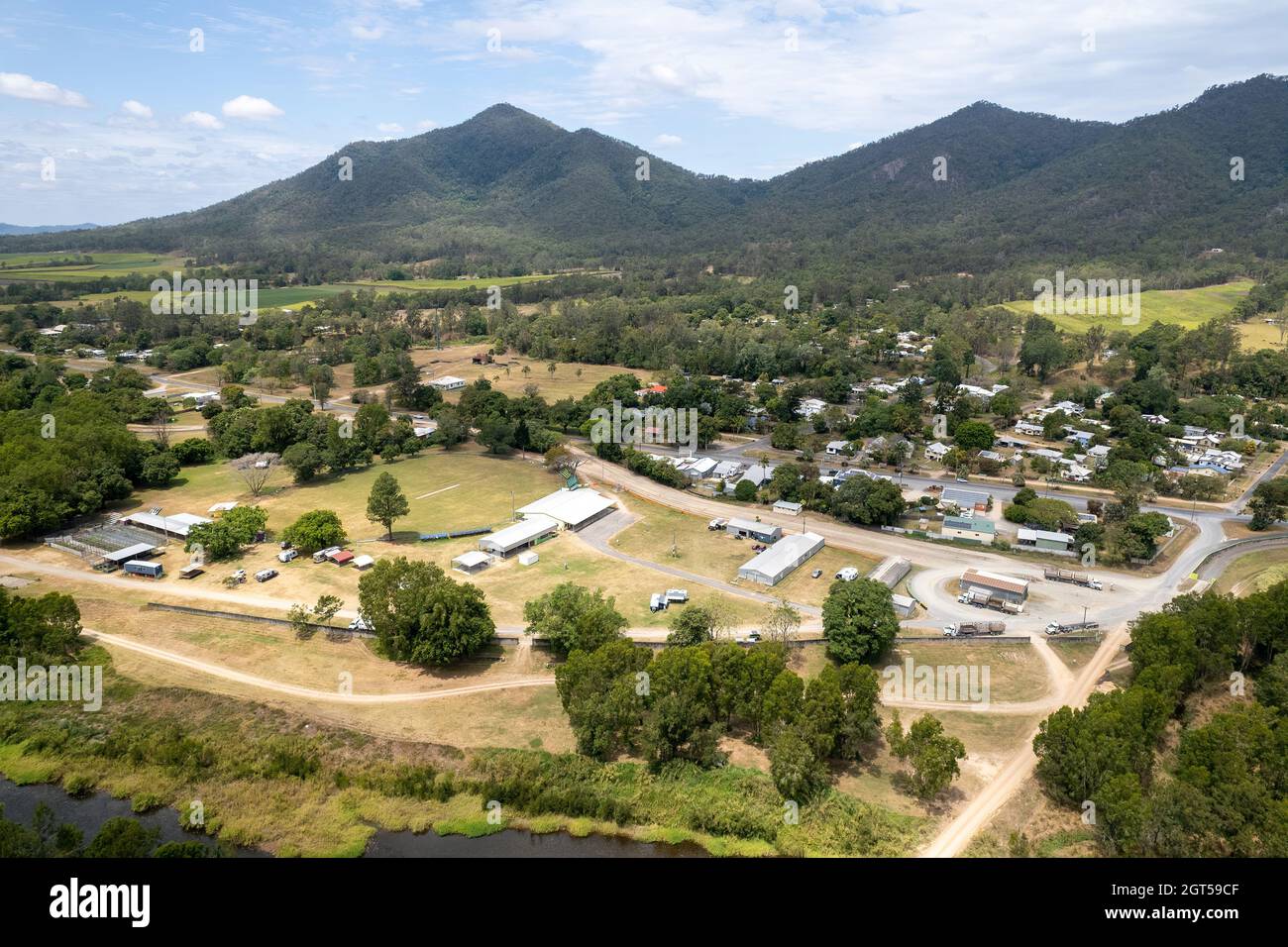 Aerial of small country town in a valley, showing semi trailers ...