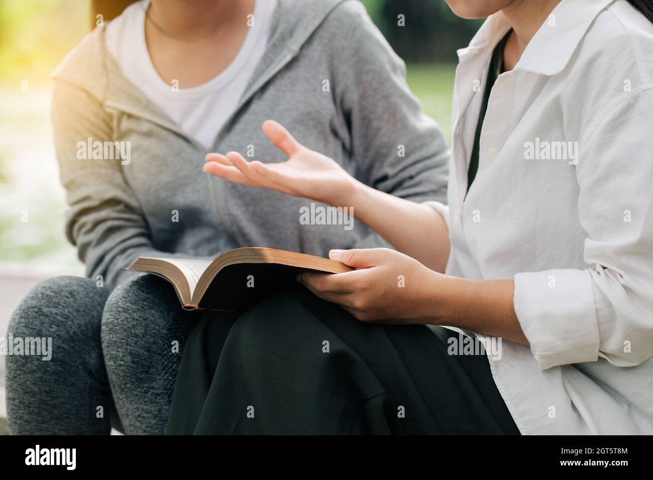 Two women talking bible open hi-res stock photography and images - Alamy