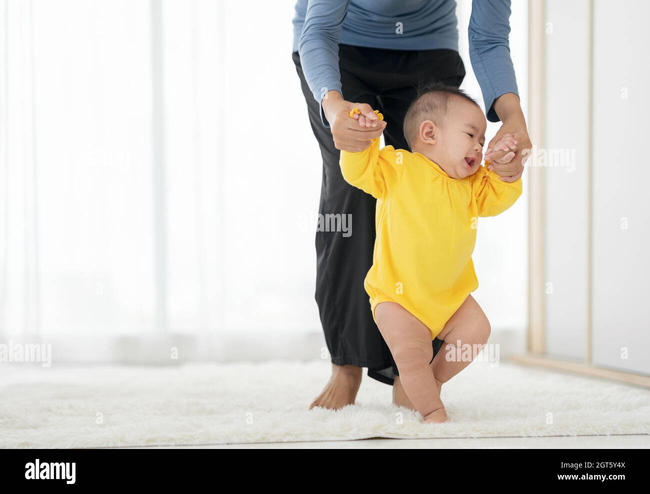 Baby takes her first steps hi-res stock photography and images - Alamy