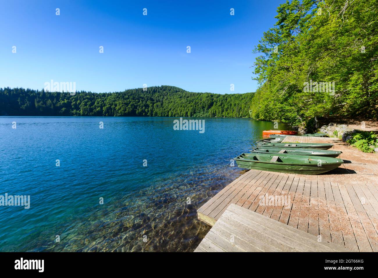 Lake Pavin in Auvergne with small boats and blue sky Stock Photo - Alamy