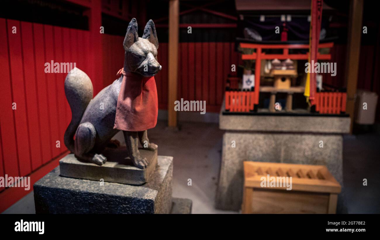 Ancient stone fox on guard at Inari Shrine in Kyoto, Japan. Traditional ...