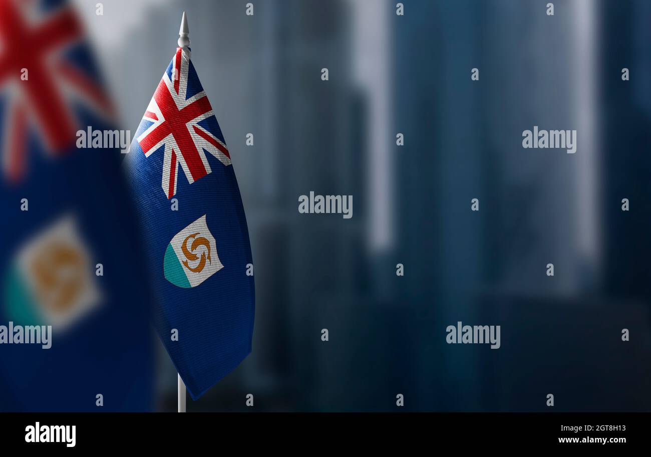 Small flags of Anguilla on a blurry background of the city Stock Photo ...