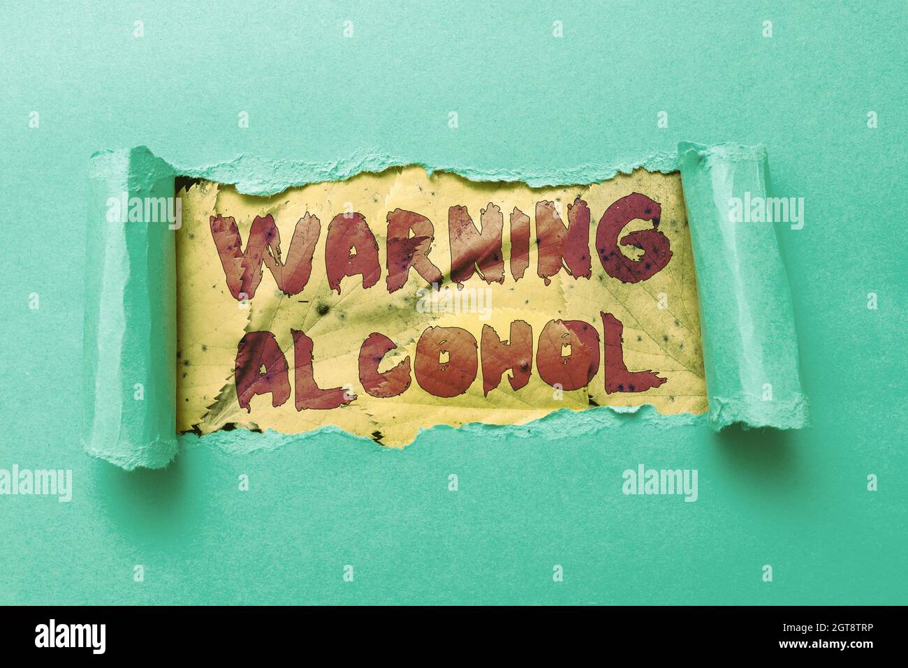 Hand writing sign Warning Alcohol. Business showcase messages appear on ...