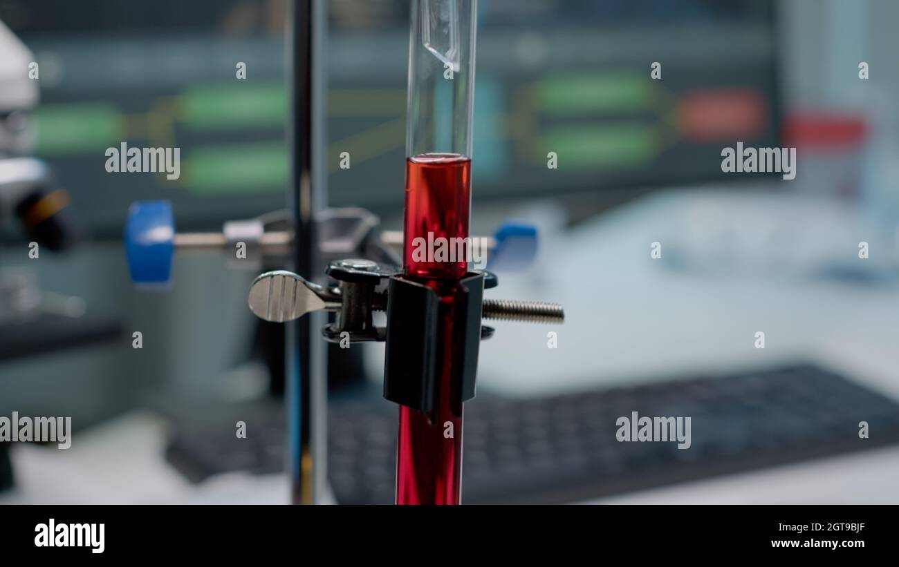 Close up of test tube with fluid blood or dna for experiment in ...