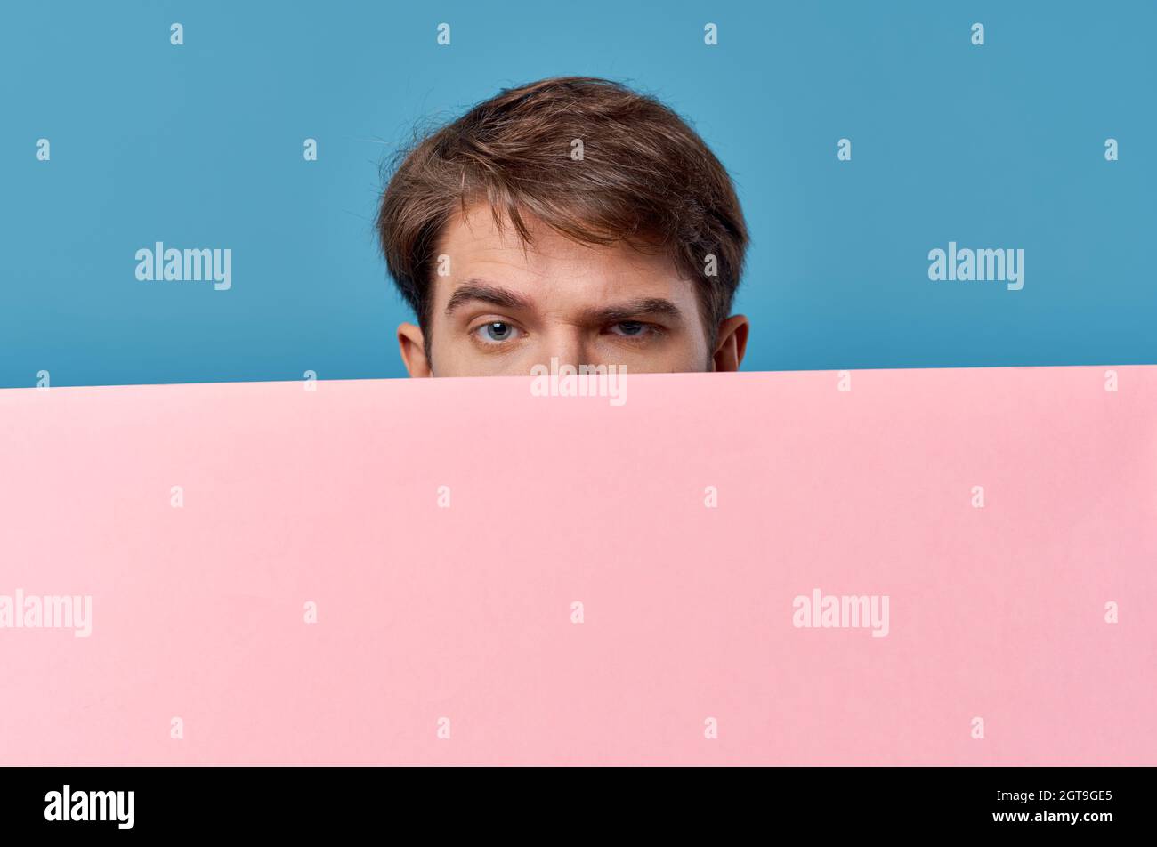 Cheerful man pink banner in hand blank sheet presentation copy-space ...