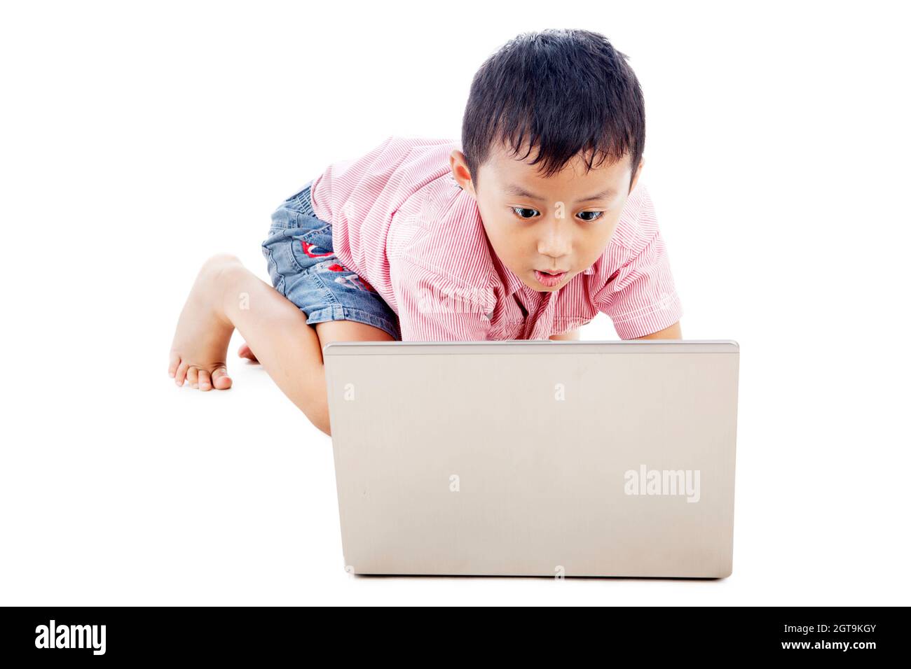 Cute Boy Using Laptop Against White Background Stock Photo - Alamy