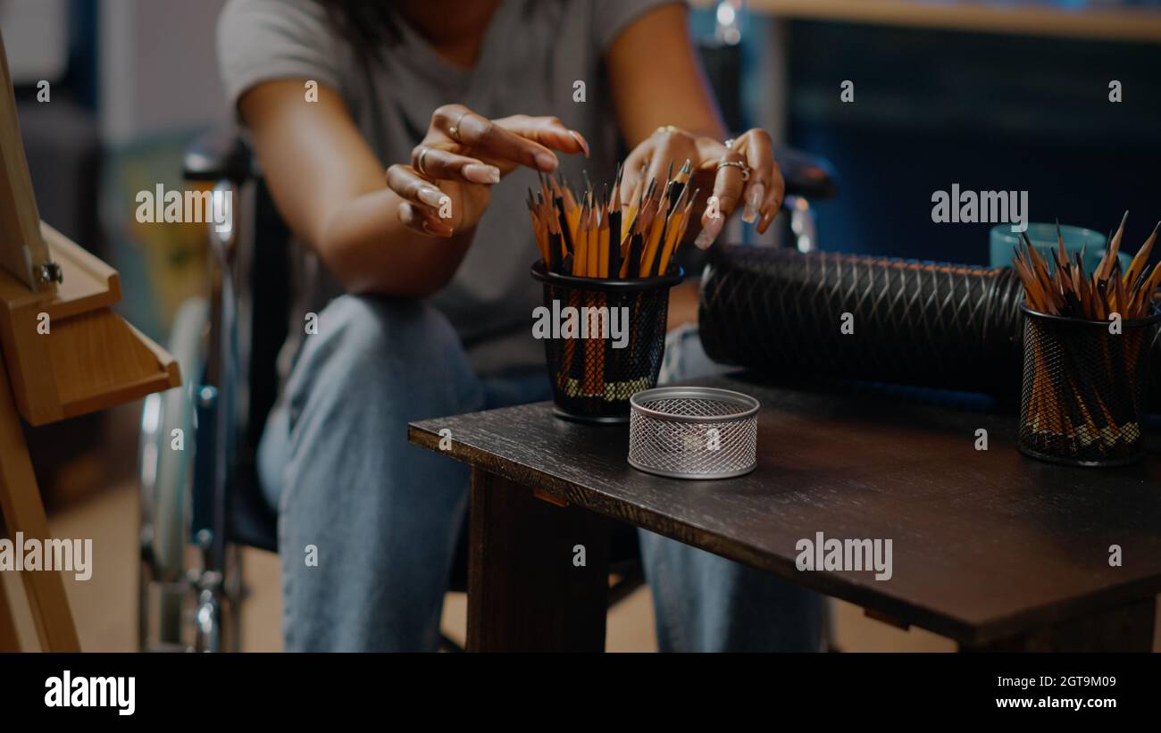 Close up of art tools and pencils on table in artwork space at home ...