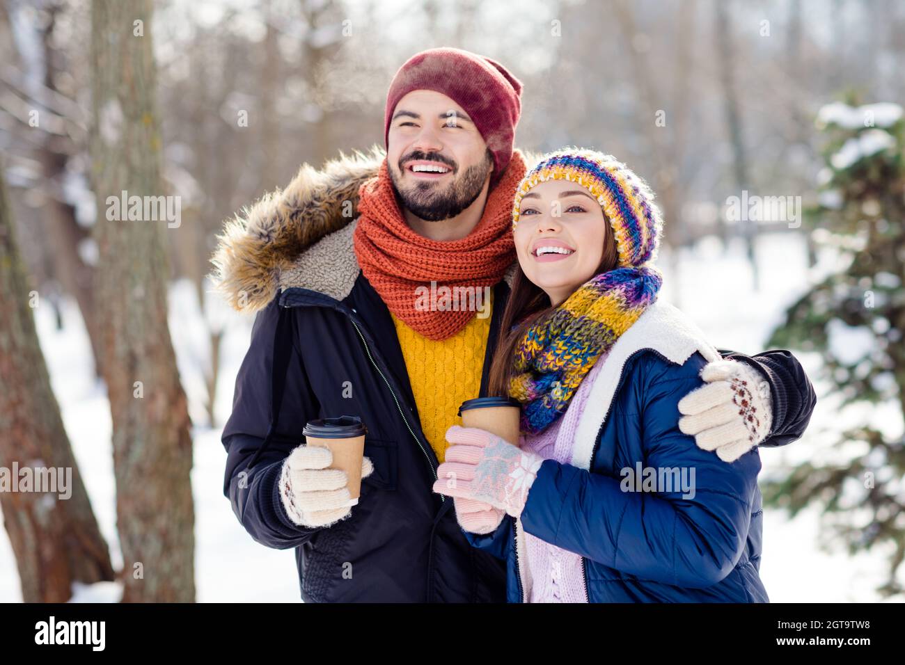 Portrait of handsome guy cuddle pretty positive lady hands hold tea ...