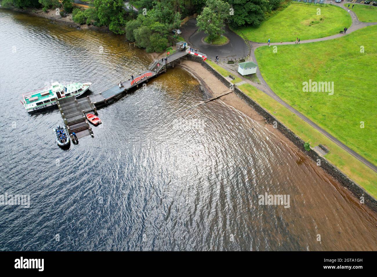 Aerial view of people and boats on a dock on the lakesh under a bright ...