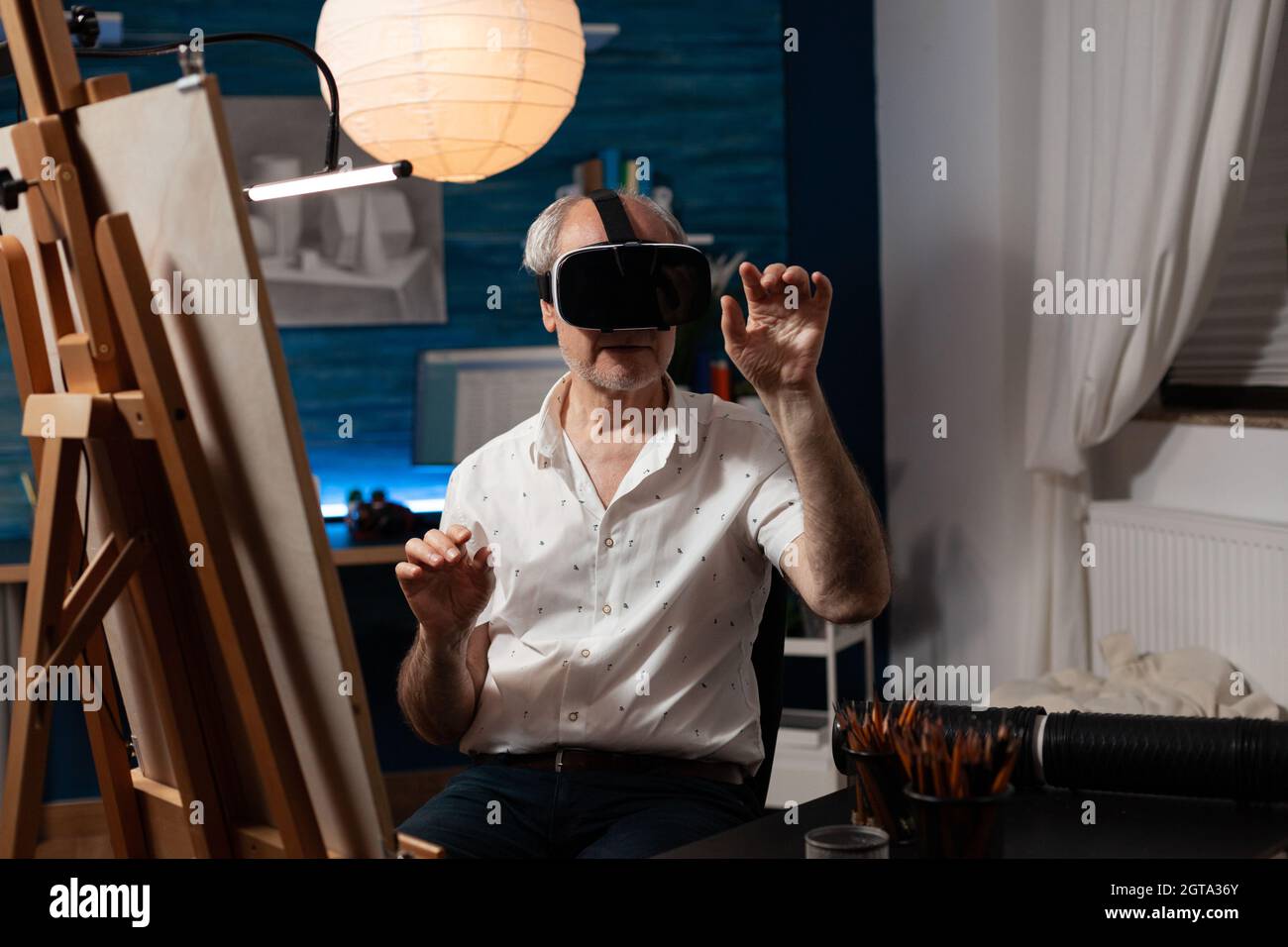 Aged adult with vr glasses seeking inspiration for realistic drawing in ...