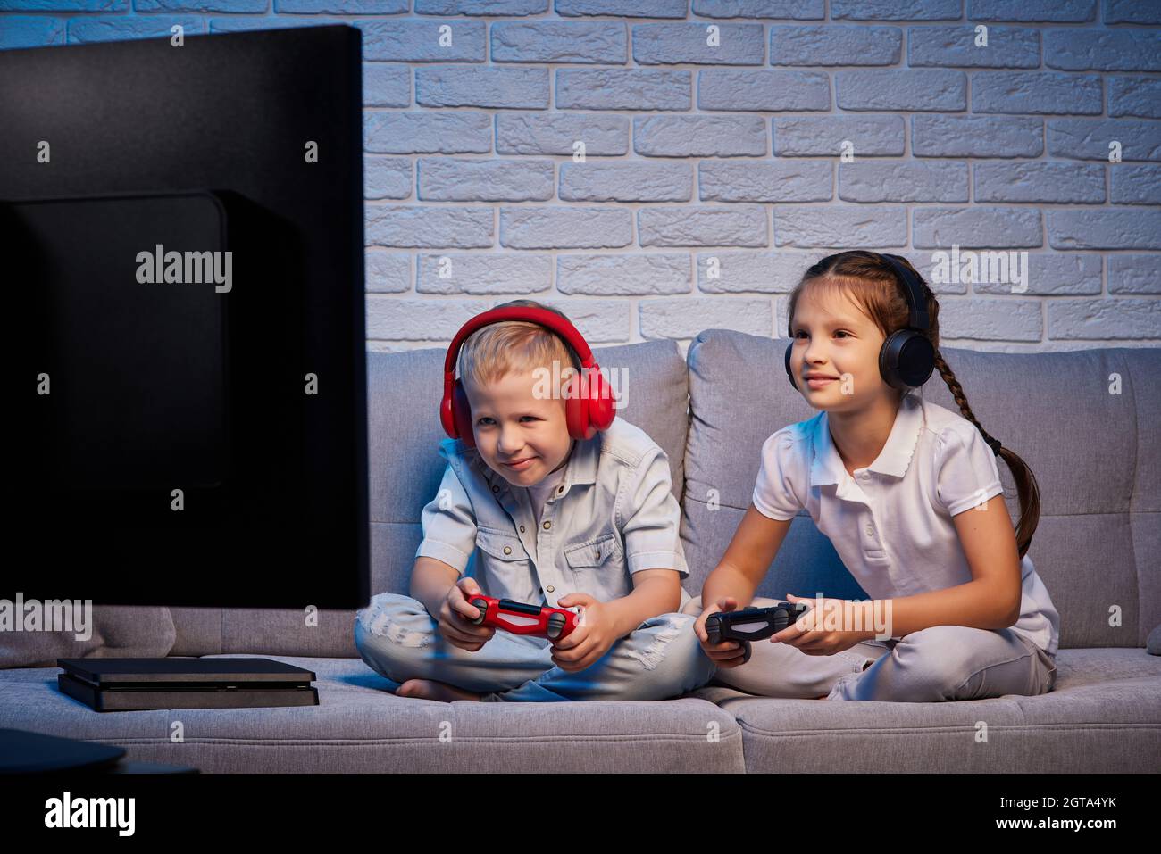 children playing video game with game console Stock Photo - Alamy