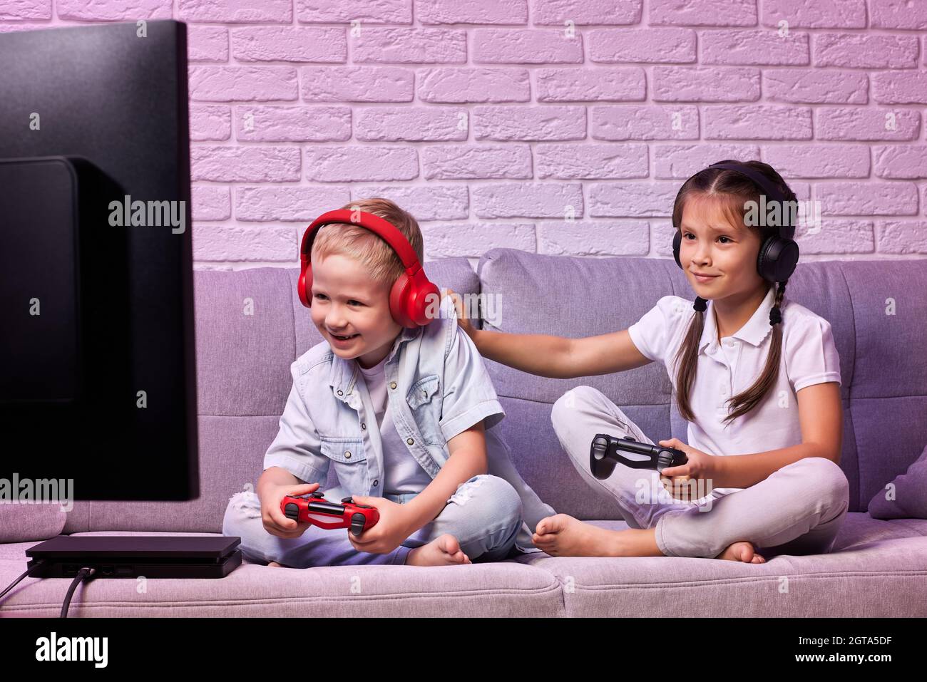 children playing video game with game console Stock Photo - Alamy