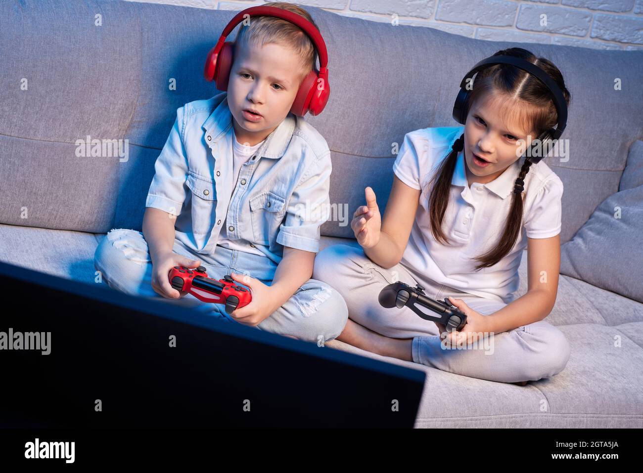 children playing video game with game console Stock Photo - Alamy