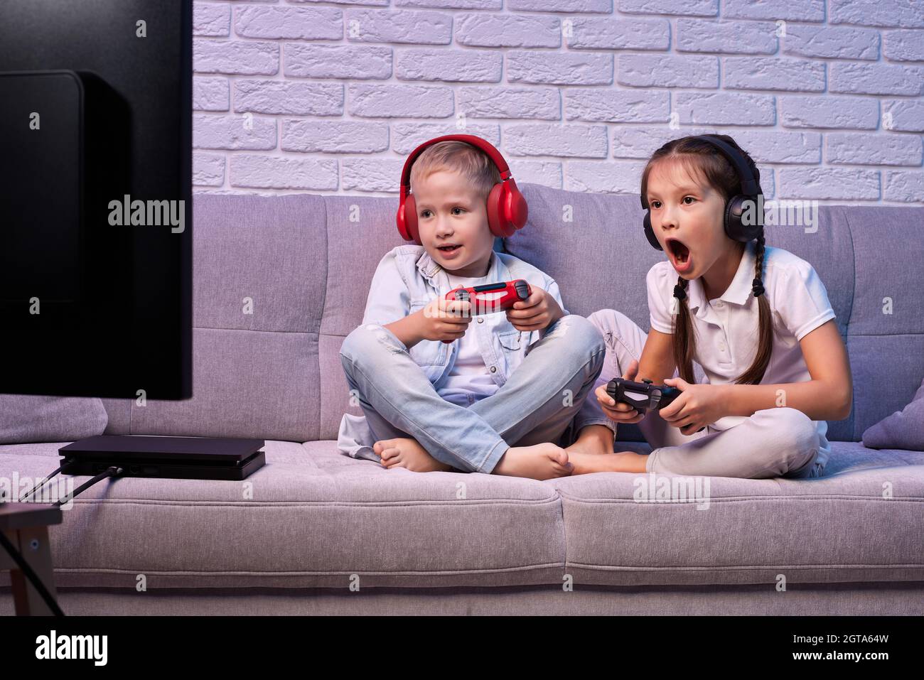children playing video game with game console Stock Photo - Alamy
