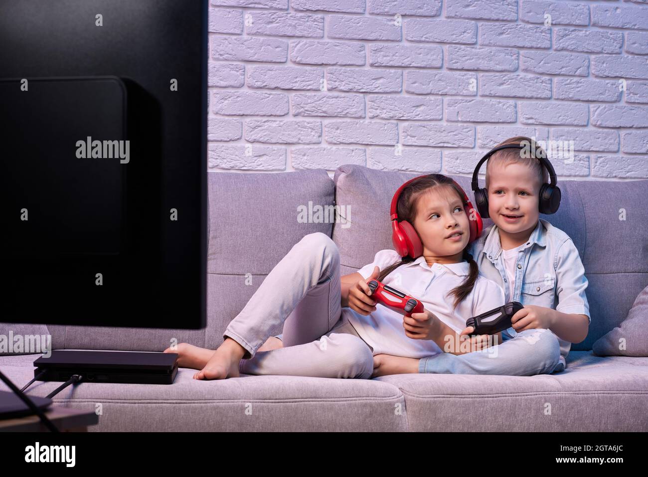 children playing video game with game console Stock Photo - Alamy