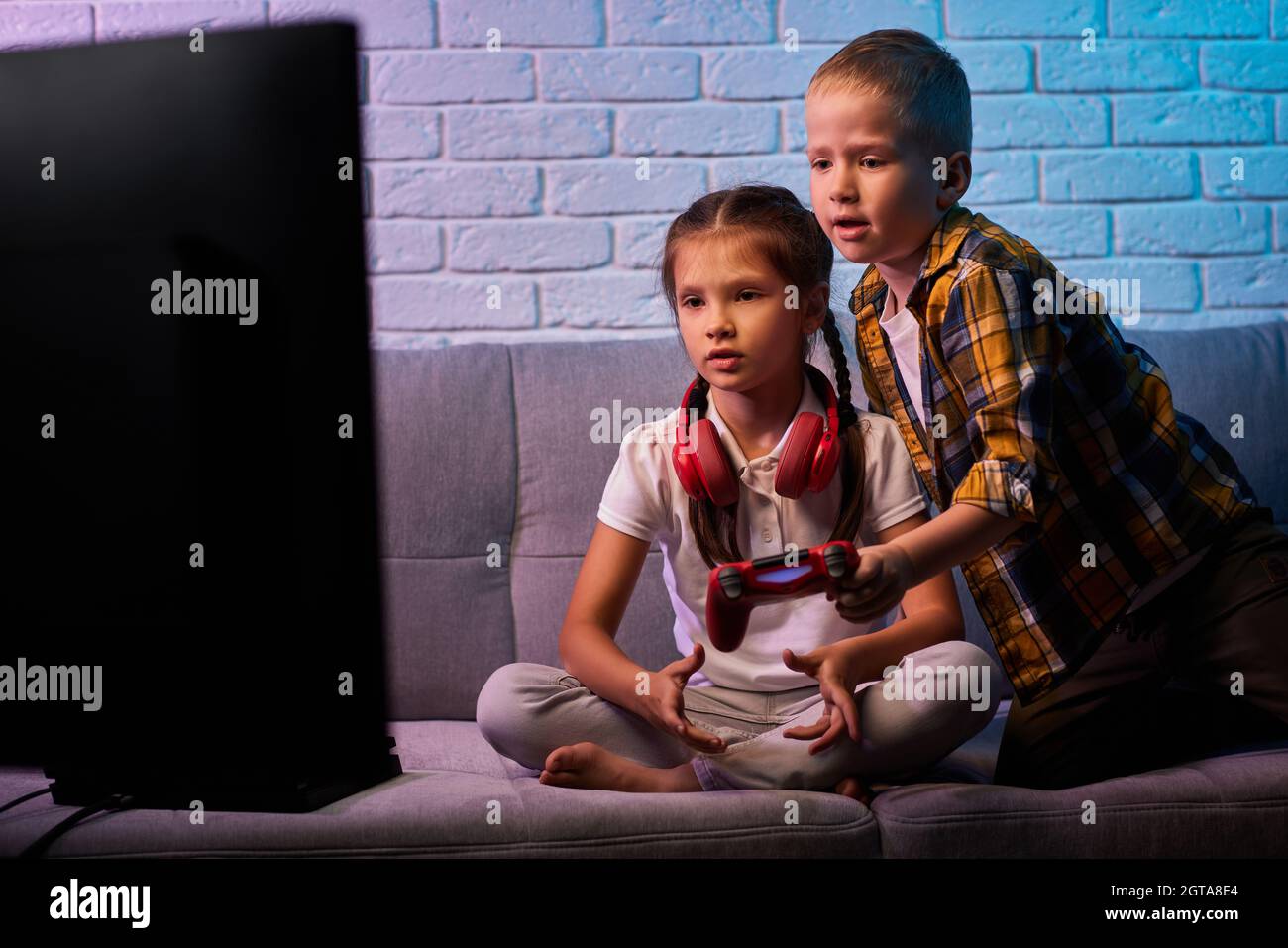 children playing video game with game console Stock Photo - Alamy