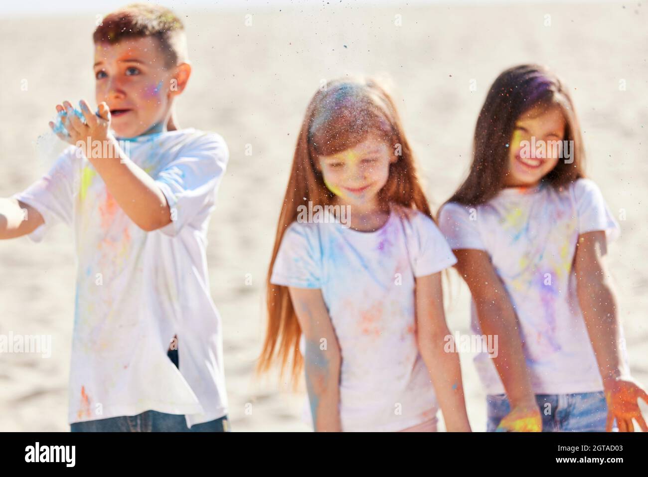 kids having fun by playing with colored powder Stock Photo - Alamy