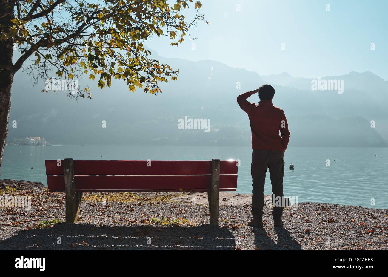 Lonely man looking at a beautiful and peaceful lake Stock Photo - Alamy
