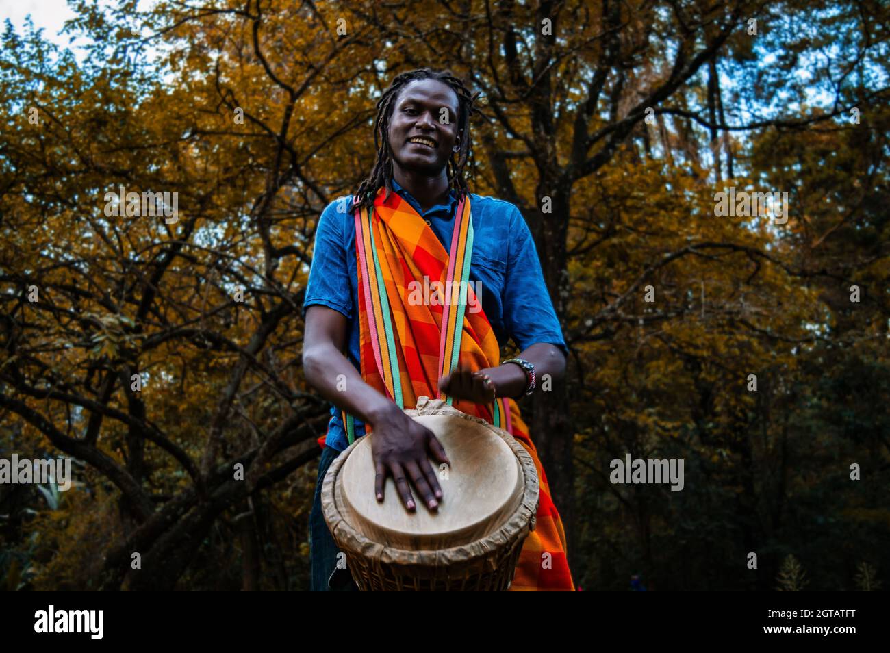 Full Length Of Man Holding Umbrella While Standing Against Trees ...