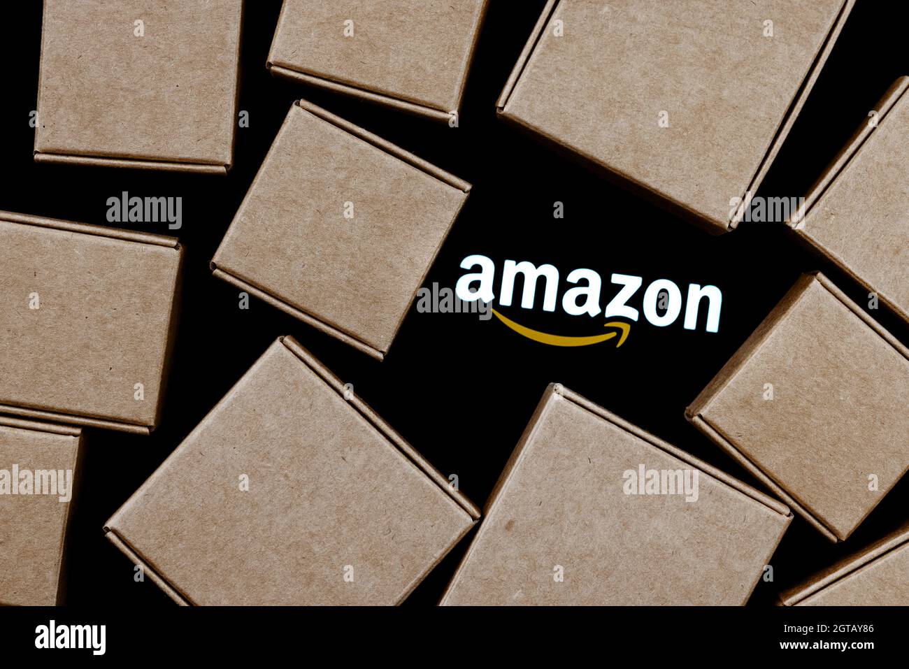 Amazon logo on a black background surrounded by parcel boxes Stock ...