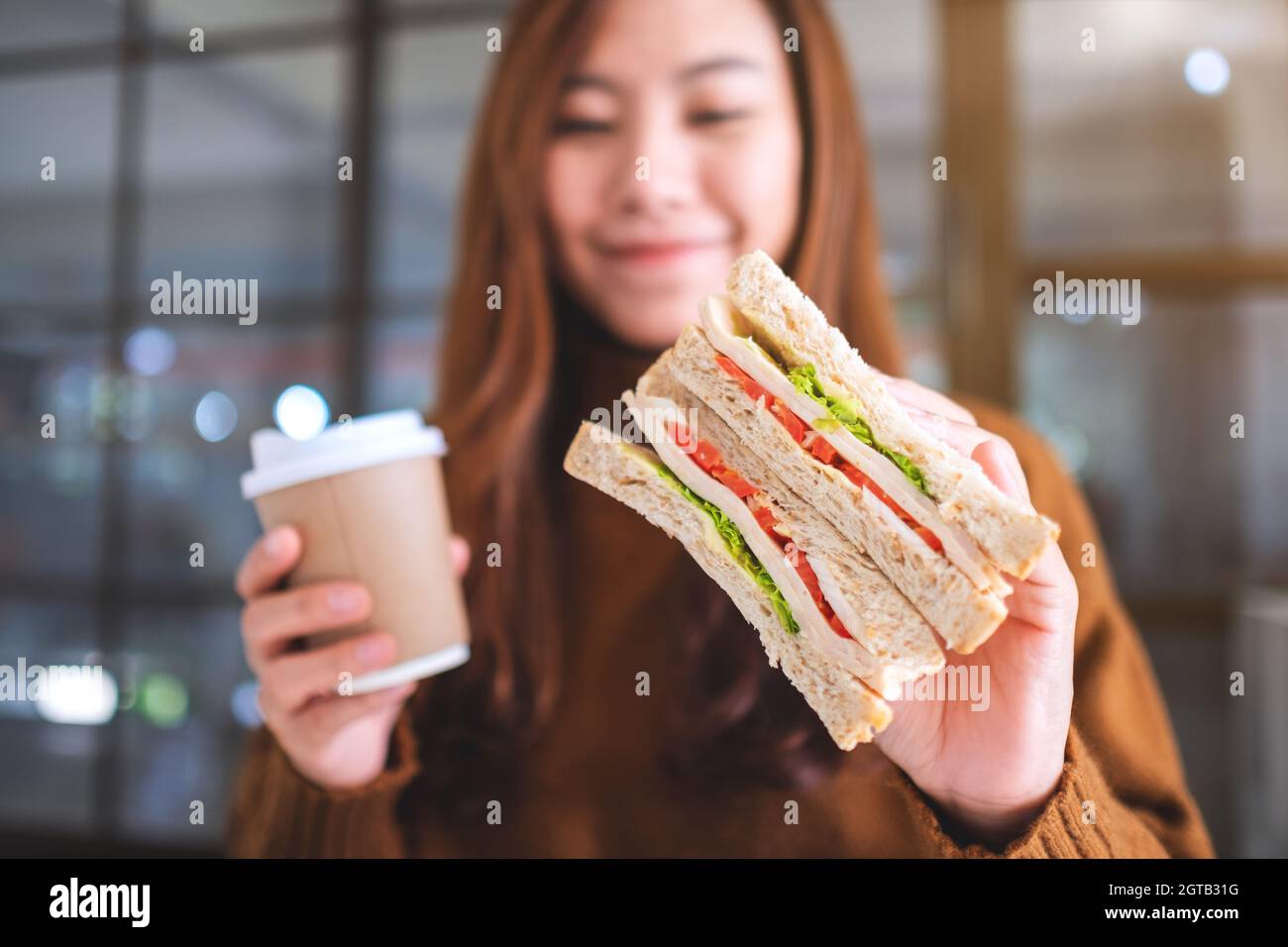 Indian woman eating sandwich hi-res stock photography and images - Alamy