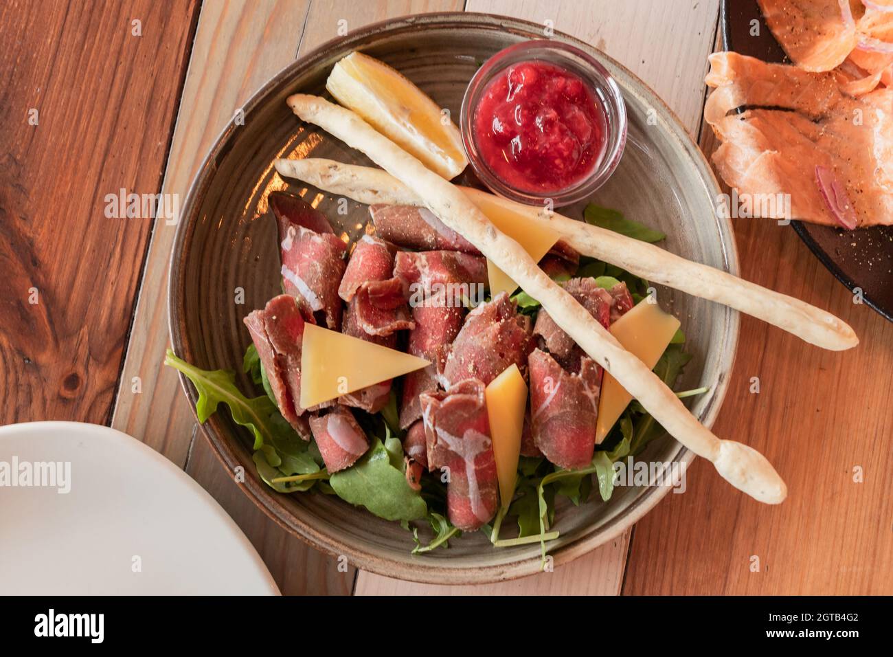 Stroganina on a plate, top view. It is a dish of the indigenous people ...
