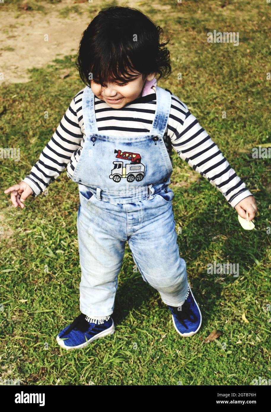 Rear View Of Boy Standing On Field Stock Photo - Alamy