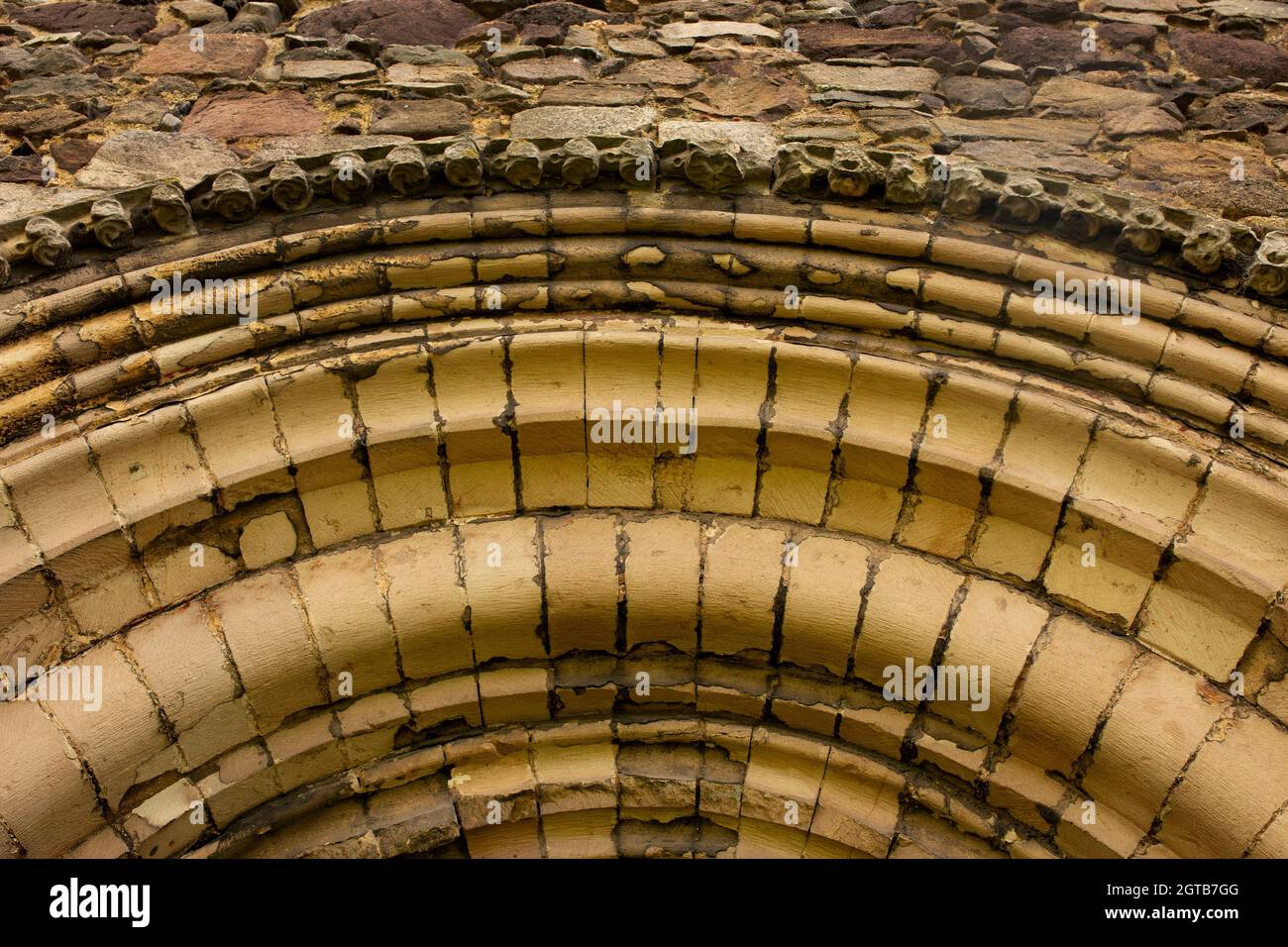 Stone arch on an entrance to a medieval abbey ruin. Medieval ...