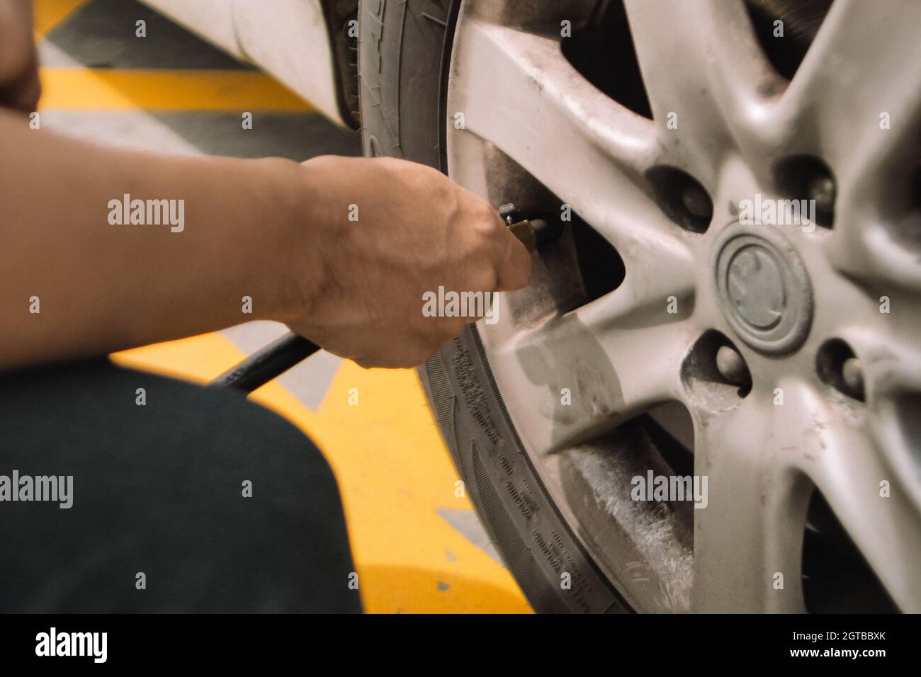 Man hand working with nitrogen tire filling system machine in car tire ...