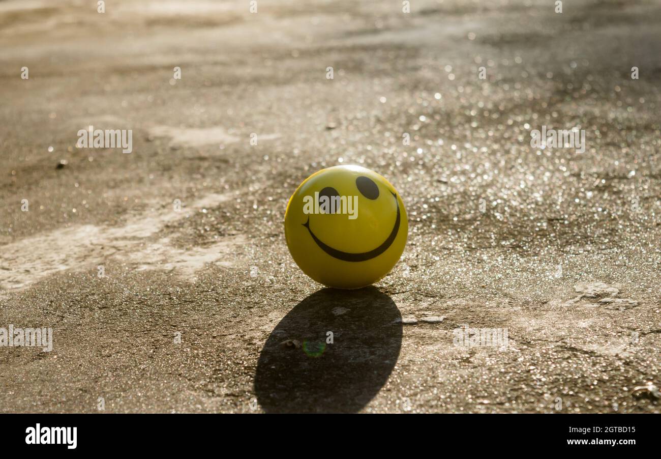 The iconic yellow smiley face with its perfect circle, two oval eyes ...