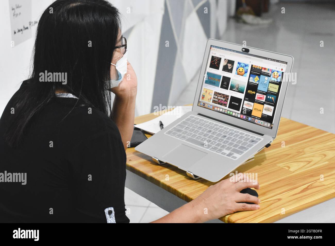 Woman mask working on laptop hi-res stock photography and images - Alamy