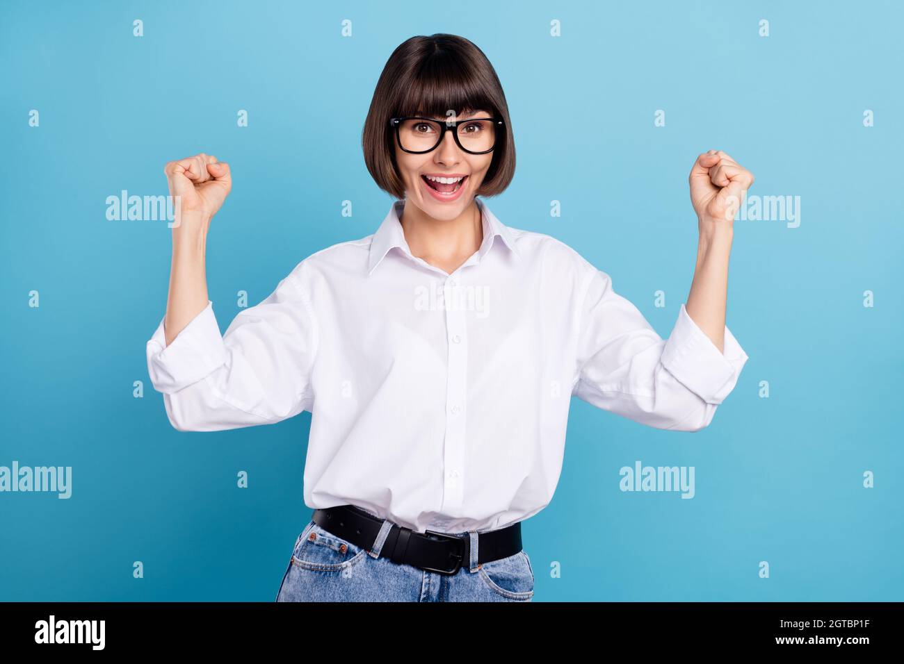 Portrait of attractive cheerful girl rejoicing having fun great success ...