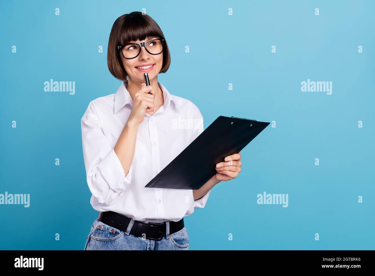 Portrait of attractive cheerful minded girl expert writing plan ...