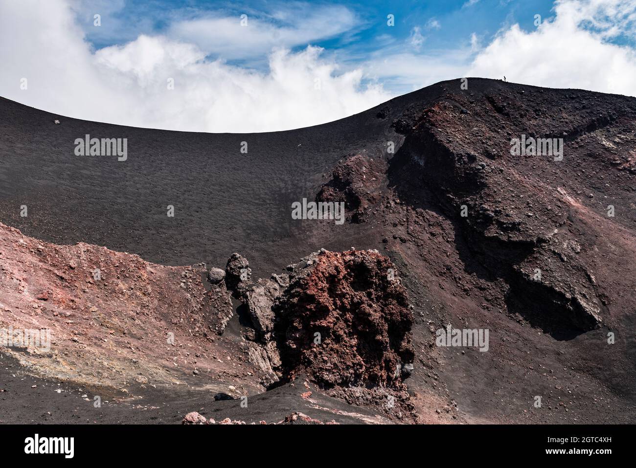 Hiking around the rim of a volcanic crater high on the slopes of Mount ...